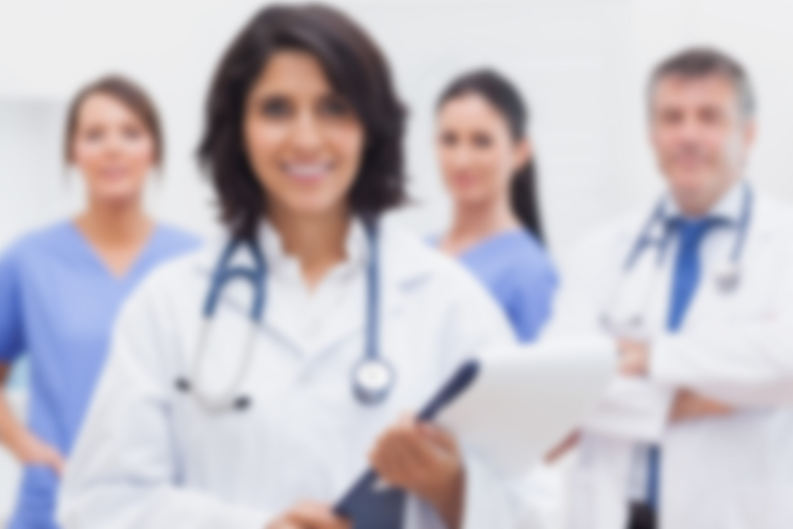 Female doctor with clipboard and her team smiling at camera – Dr ...